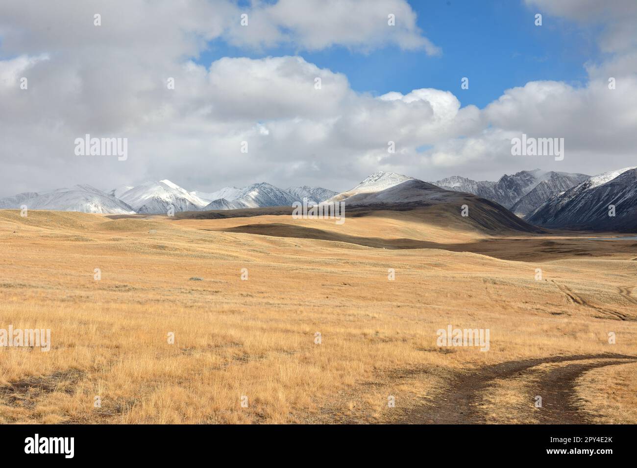 Field roads cross high hills in the dry autumn steppe at the foot of ...