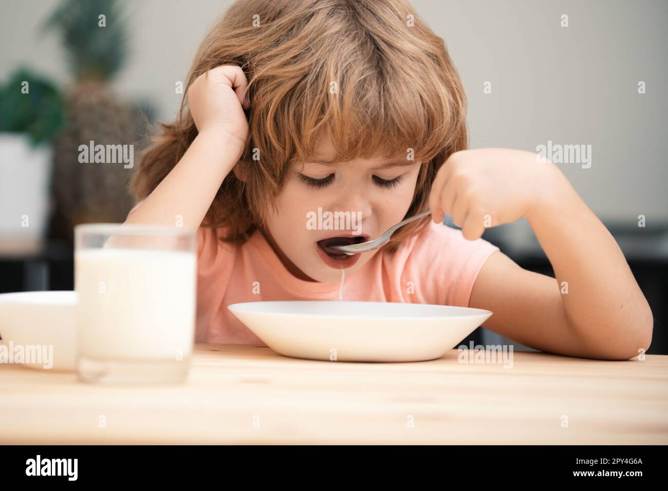 Closeup face of kid eating organic food, yogurt, milk. Child healthy ...