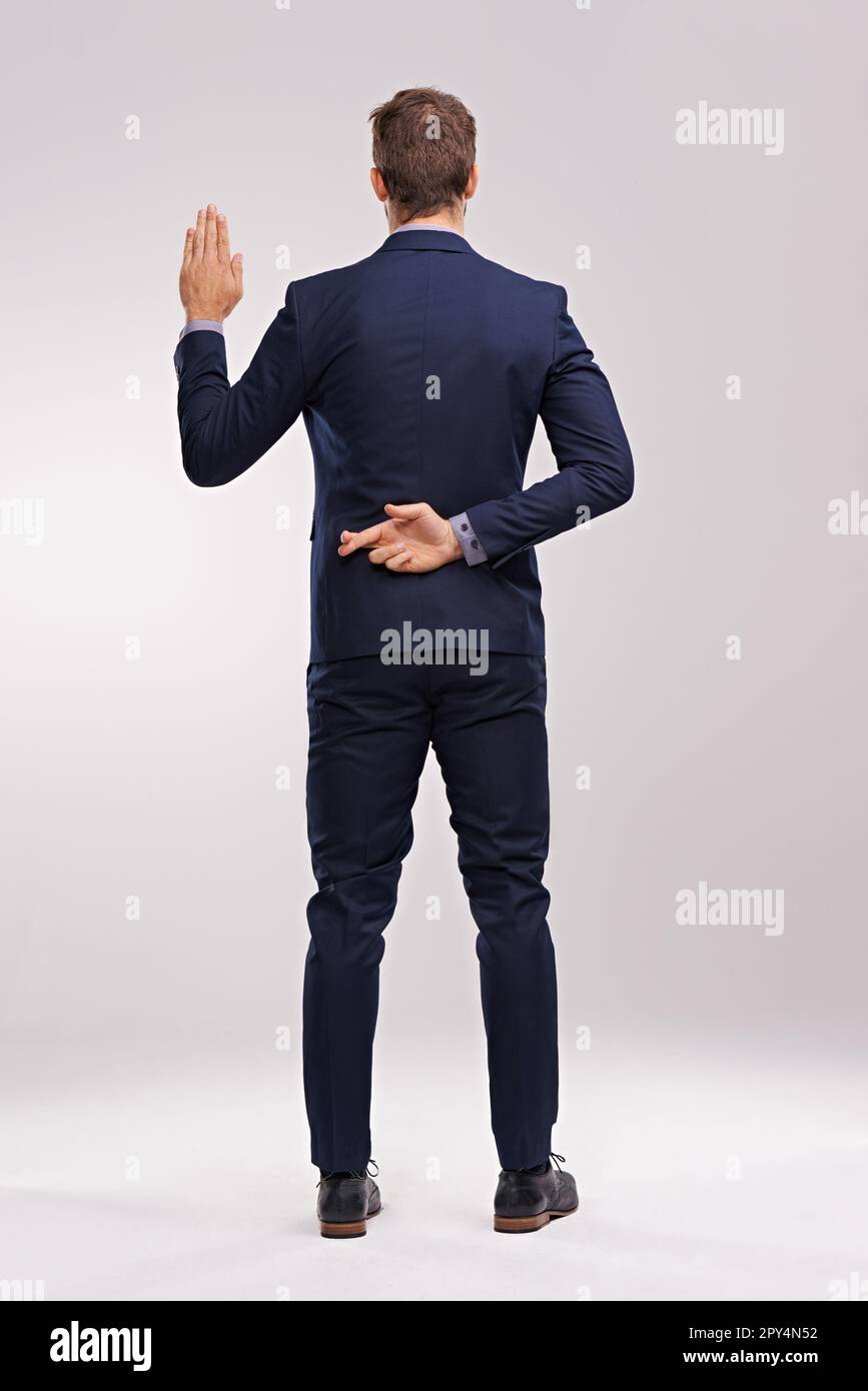 Back of businessman, taking an oath and fingers crossed in a white ...