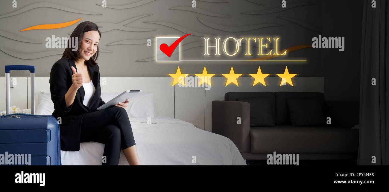 Asian businesswoman in black suit sitting with tablet computer in her ...