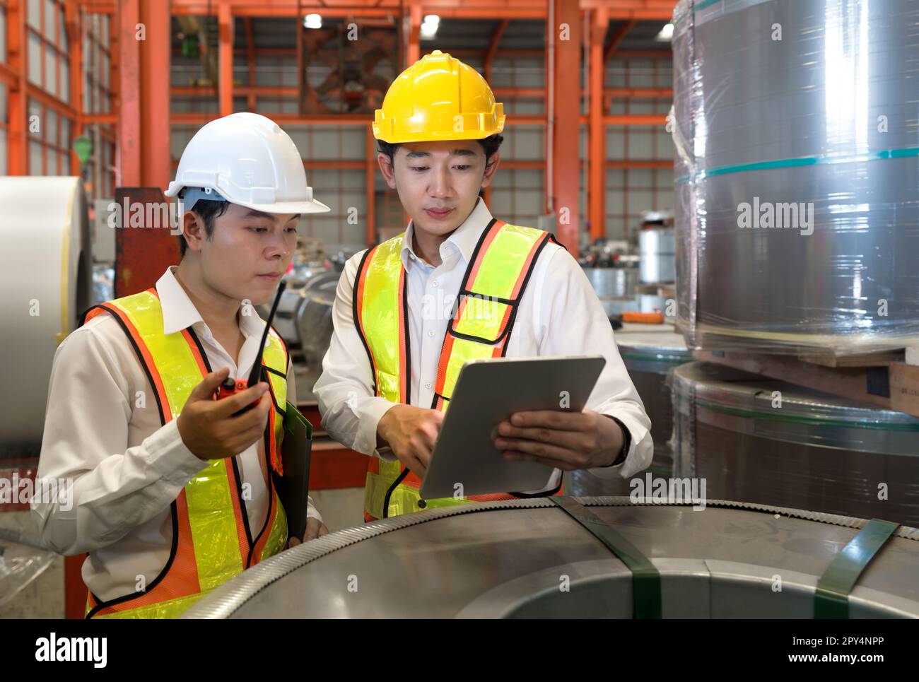 Young asian engineer manager trains new employees within the metal ...