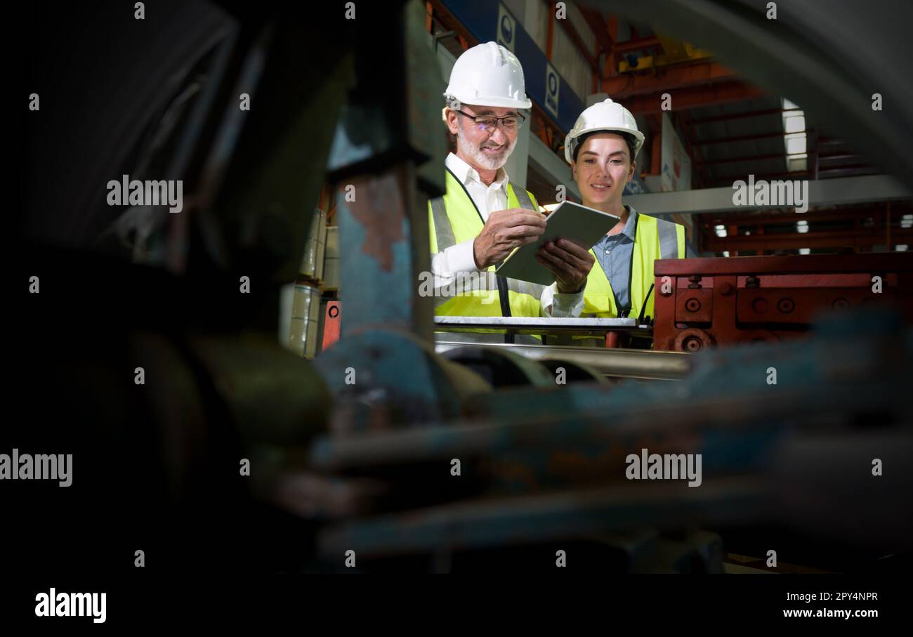 Senior engineer manager trains new employees within the metal sheet ...
