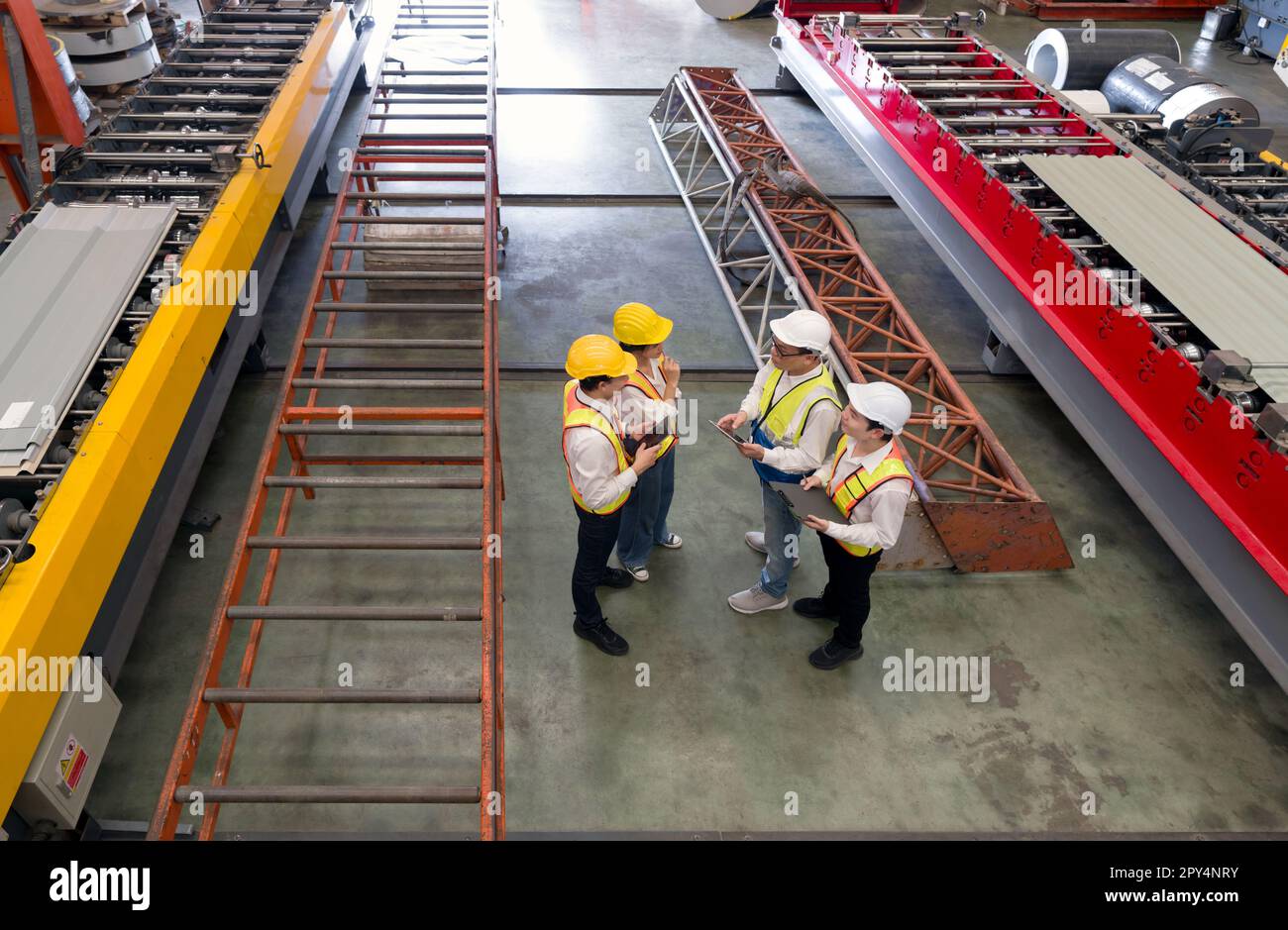 Senior engineer manager trains new employees within the metal sheet ...