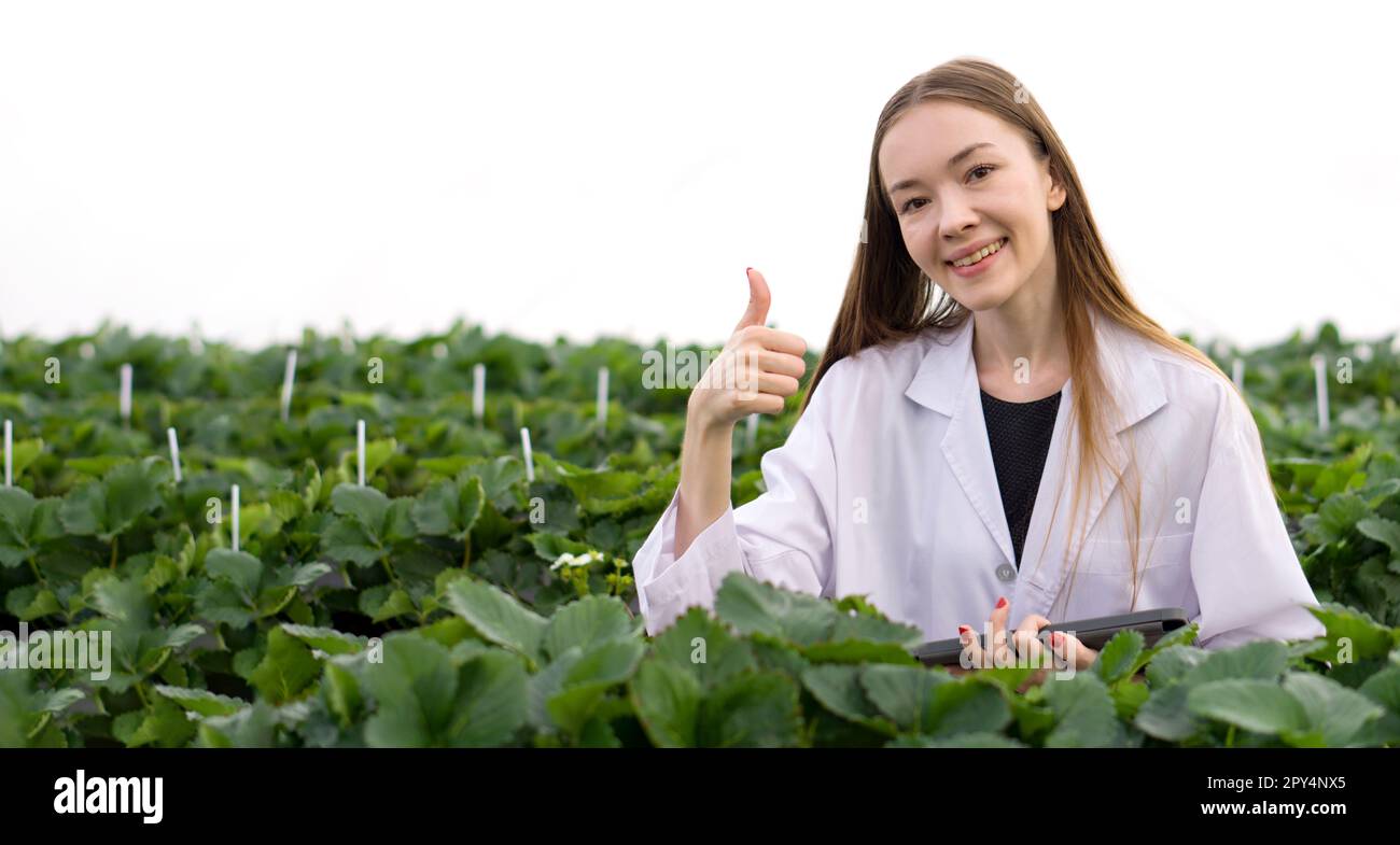 Caucasian female botanical scientist raise finger thumb up while ...