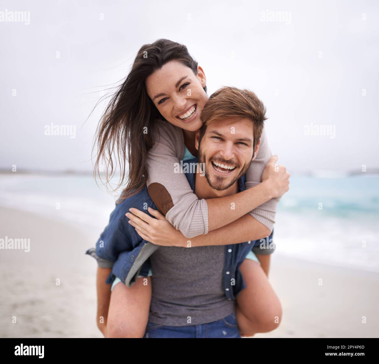 Couple, portrait and piggyback hug at beach for travel, romance and ...