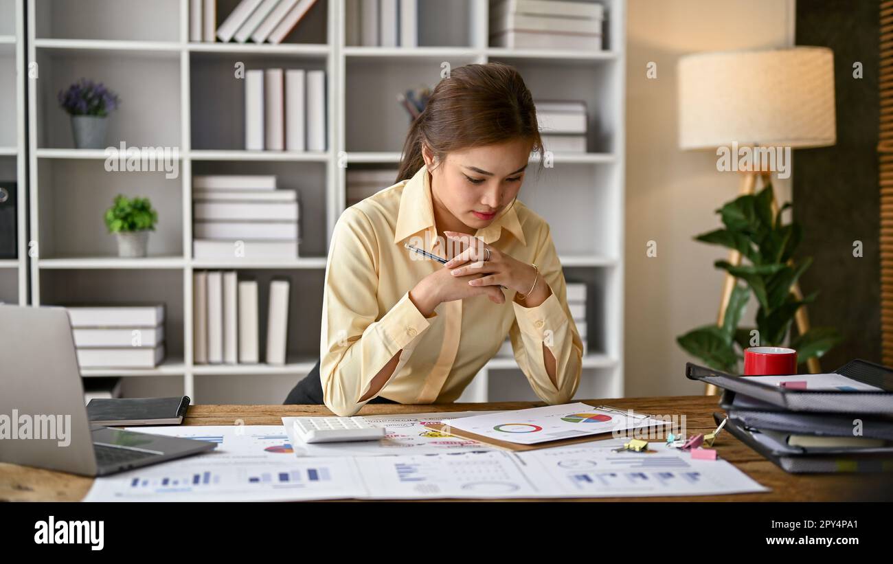 Professional and focused millennial Asian businesswoman or female boss ...