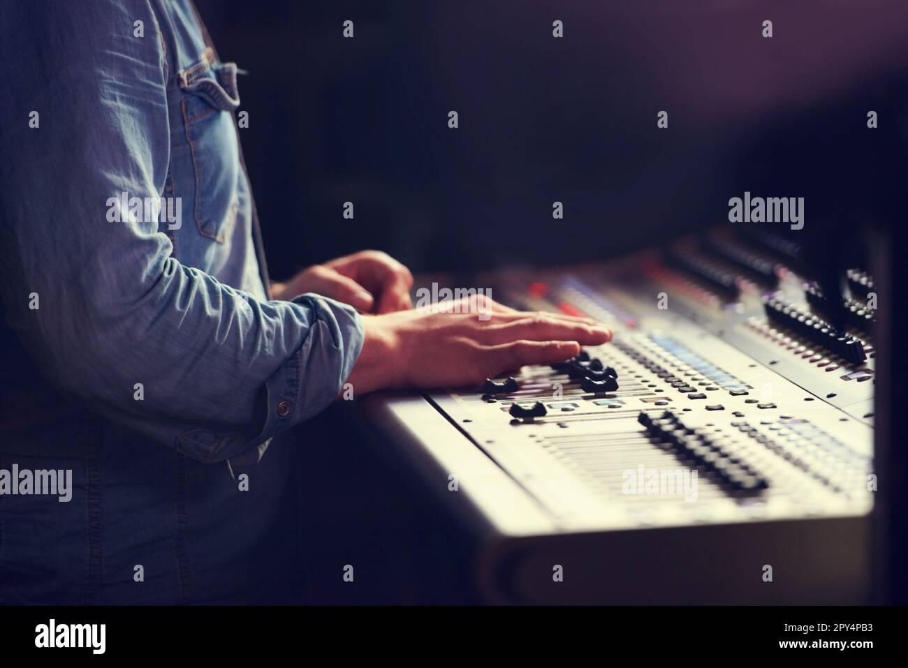 Closeup, hands and sound engineer with a mixing desk, music and artist ...