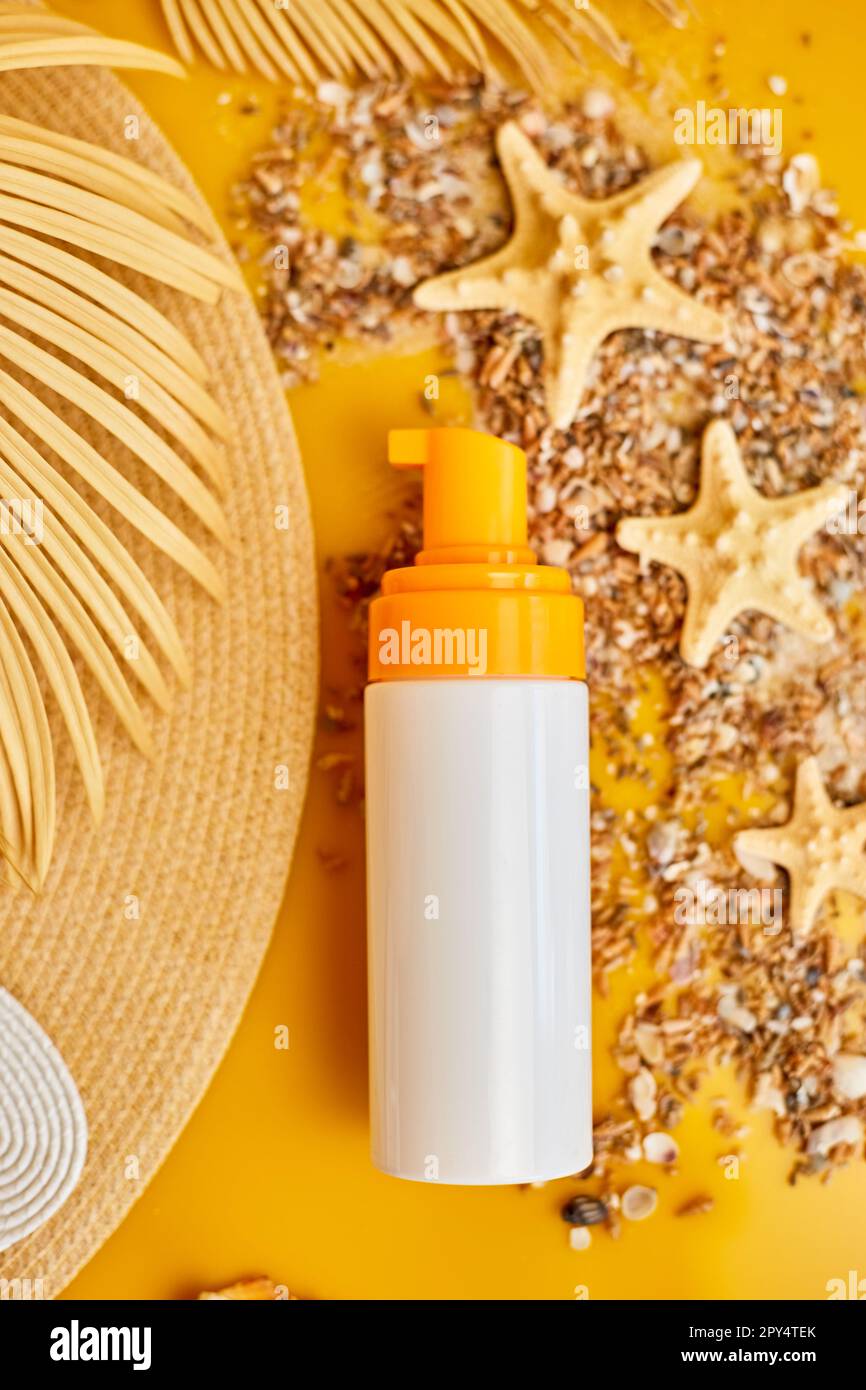 Flat lay, top view Sunscreen tube mockup with shells, sand yellow ...