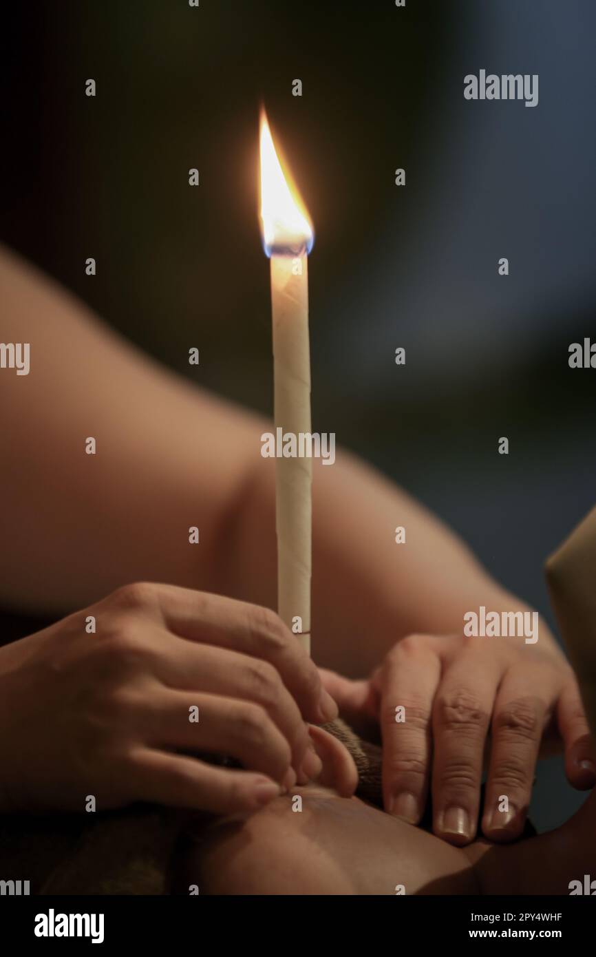 Woman Receiving Ear Candle Treatment At Spa Ear Coning Or Thermal
