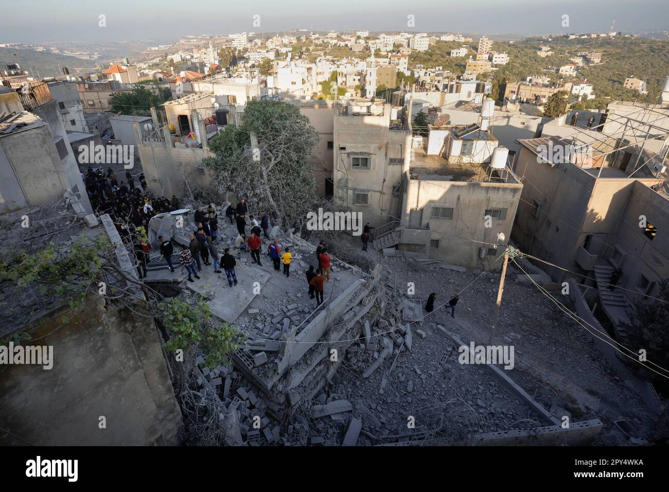 Palestinians inspect the ruins of the house of Palestinian militant ...
