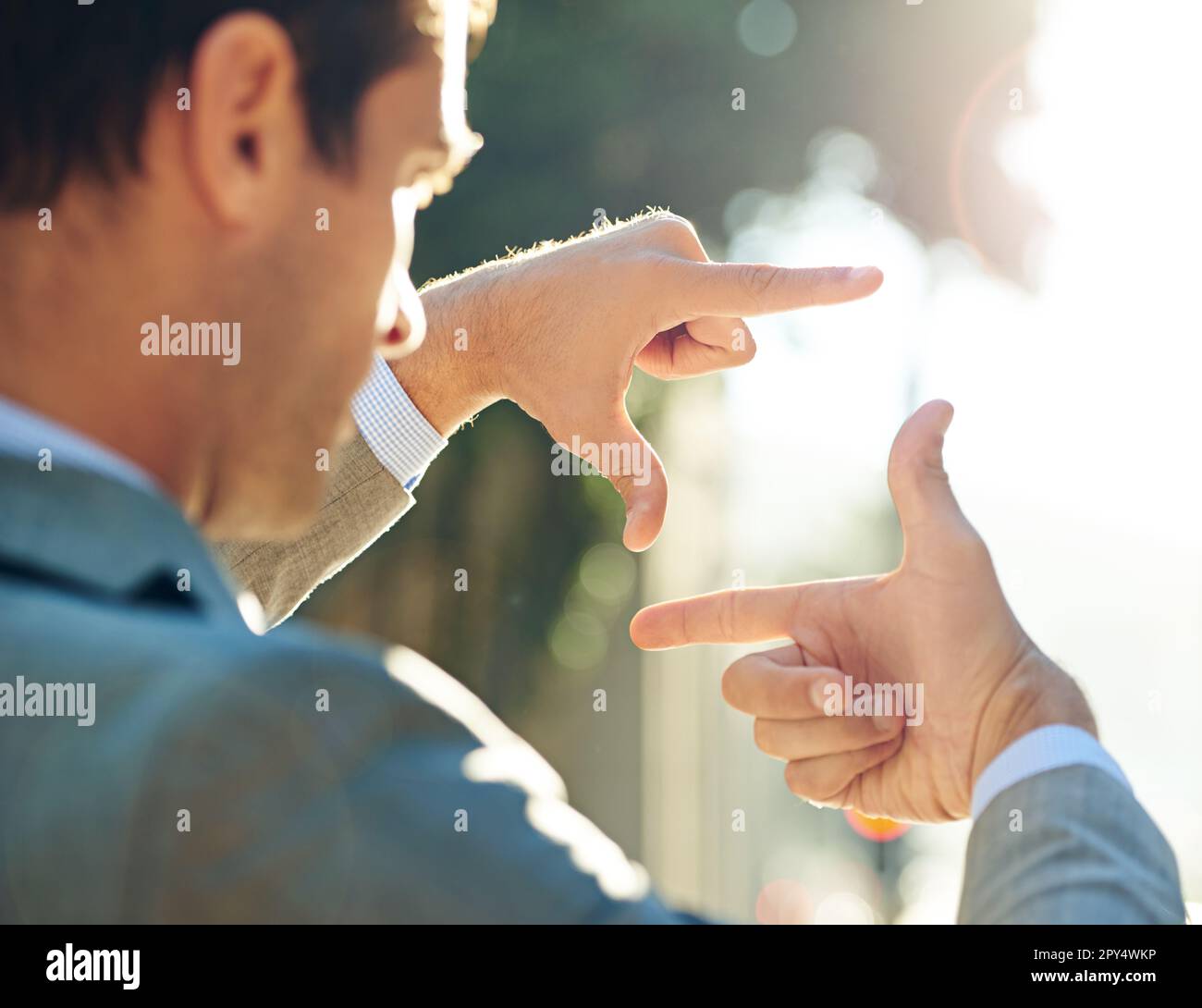 Hand, frame and business man in city for vision, focus and thinking ...