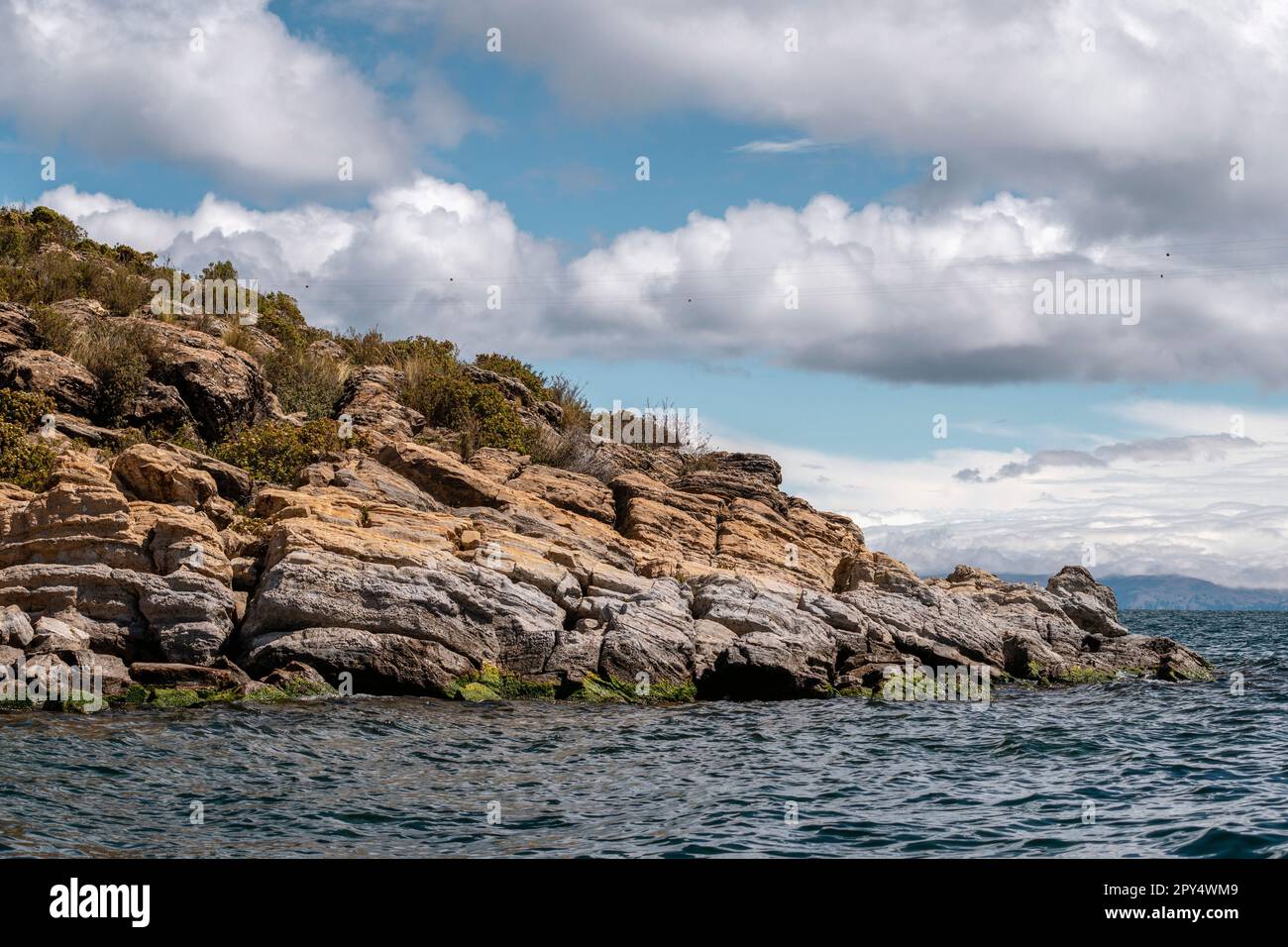 rocky cape fragment of Isla de la Luna (Island of the Moon) at lake ...