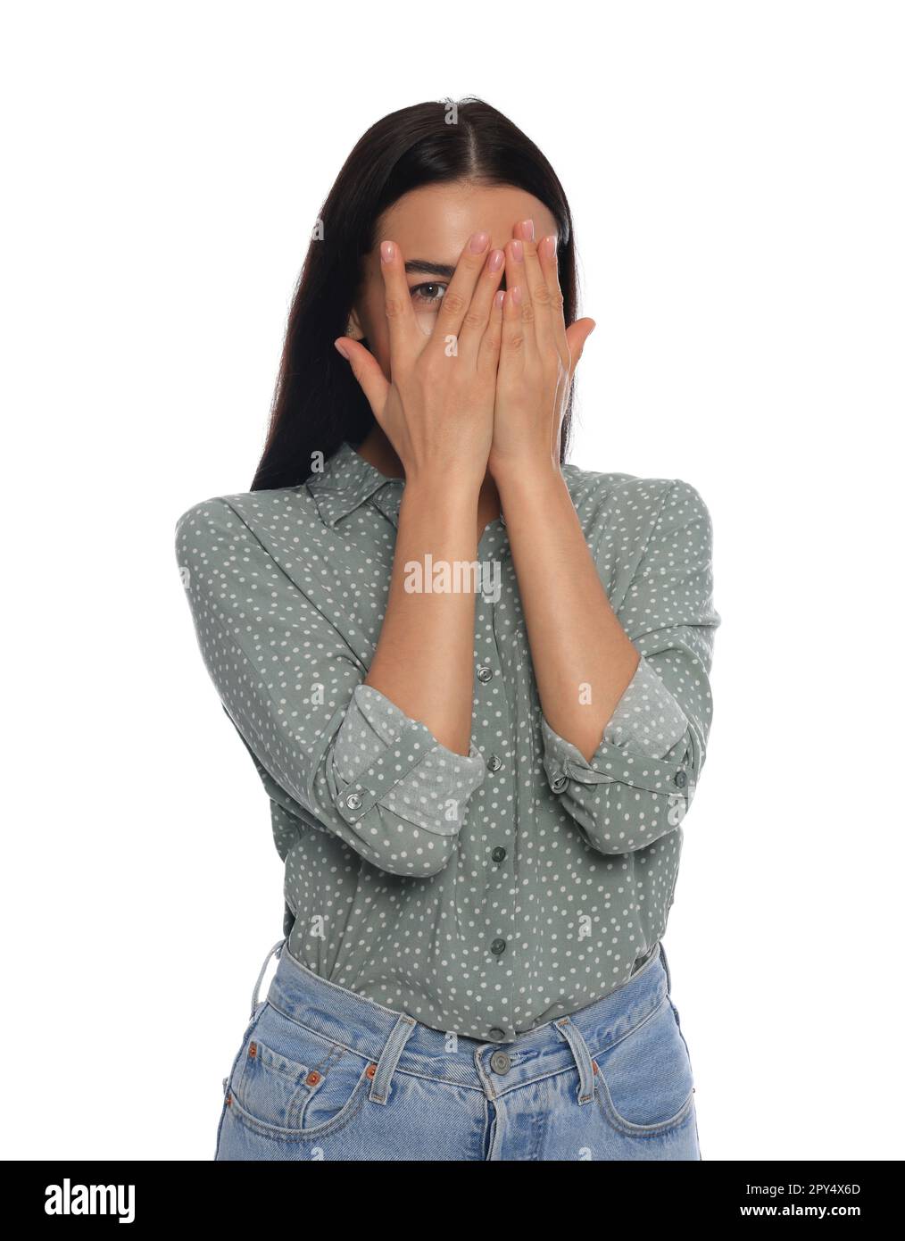 Embarrassed young woman covering face with hands on white background ...