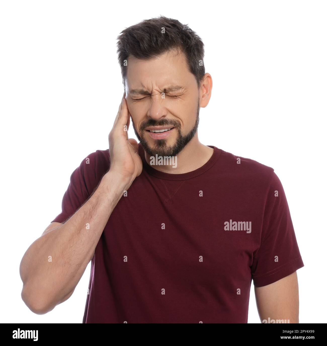 Man suffering from ear pain on white background Stock Photo - Alamy