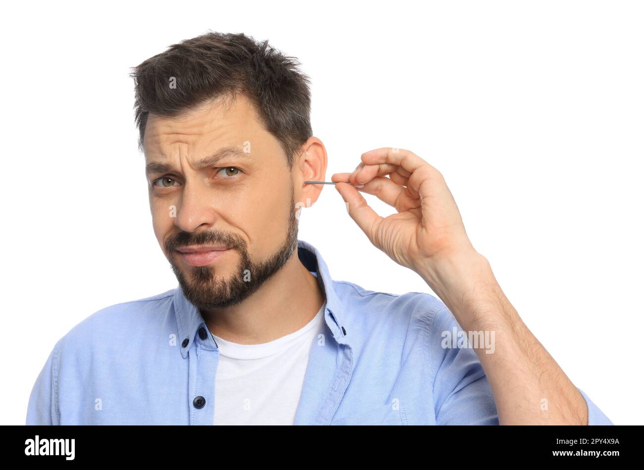 Emotional man cleaning ears on white background Stock Photo - Alamy