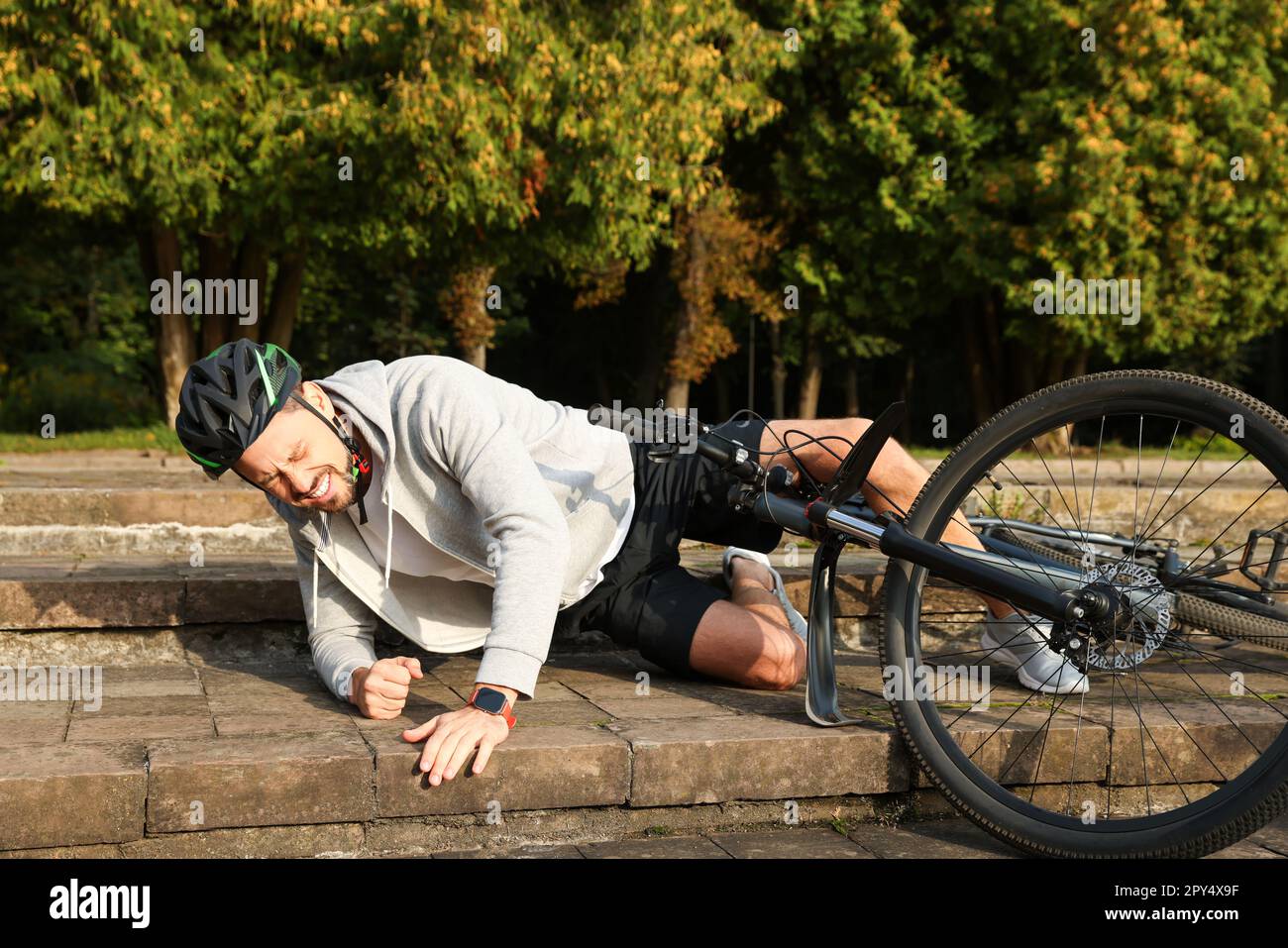 Man fallen off his bicycle on steps outdoors Stock Photo - Alamy