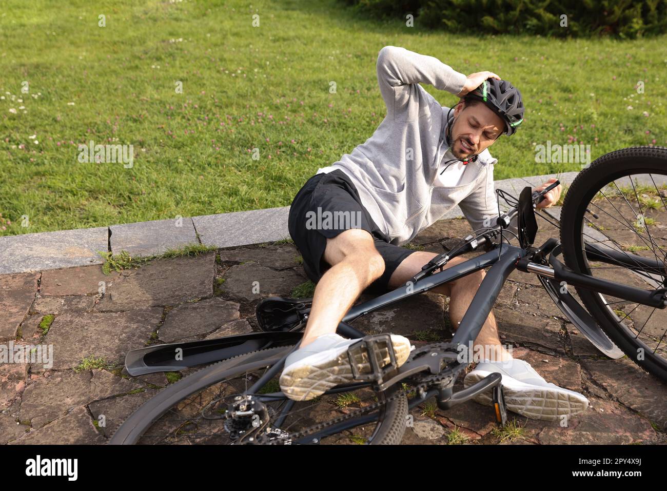 Man fallen off his bicycle in park Stock Photo - Alamy