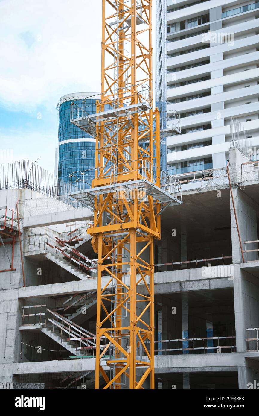 Construction site with tower crane near unfinished building Stock Photo ...