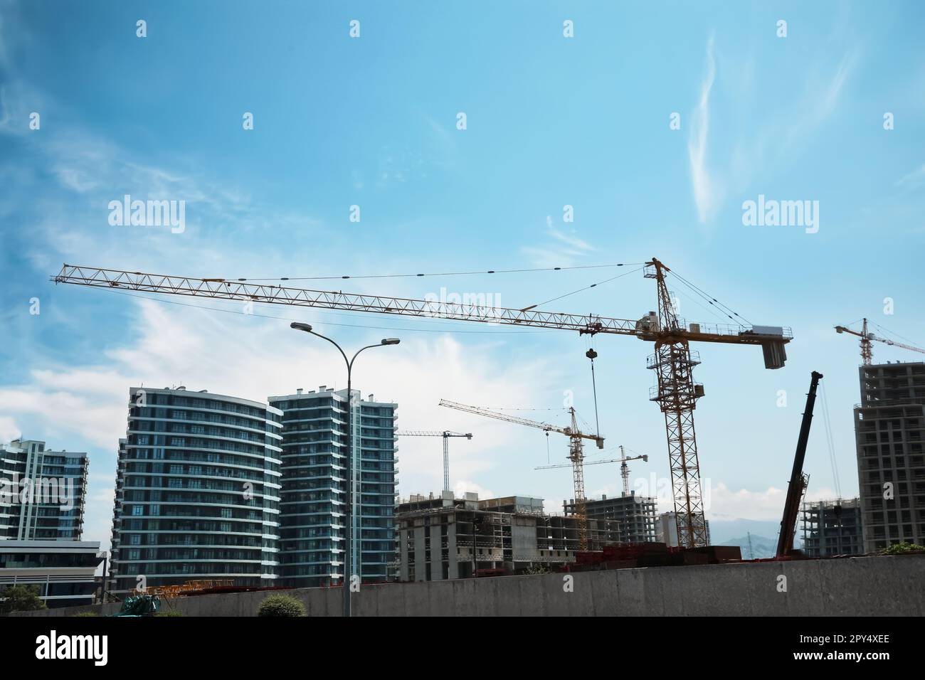 Construction site with tower cranes near unfinished buildings Stock ...