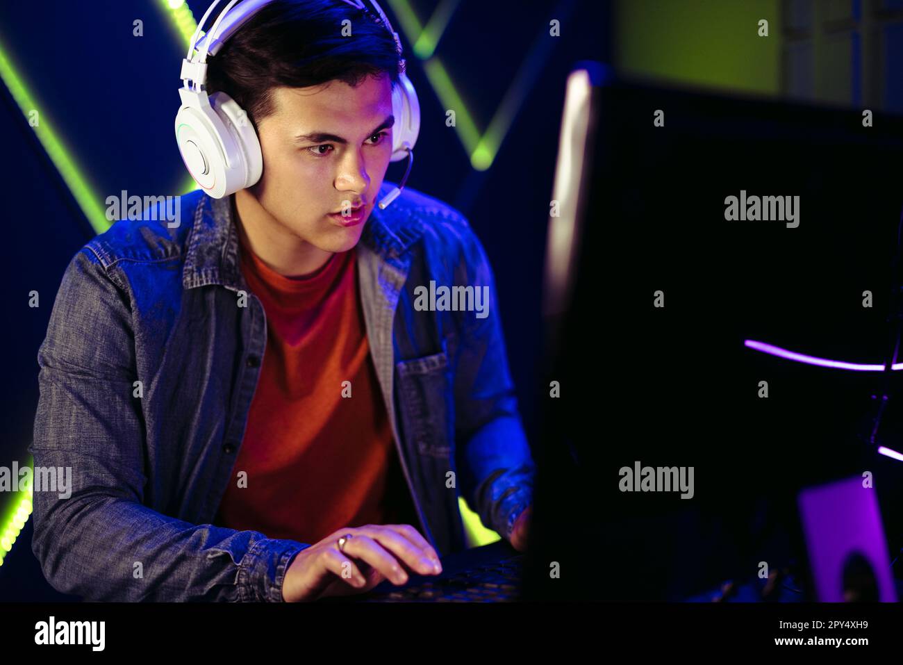 Male gamer engaging with the online gaming world. With a headset ...