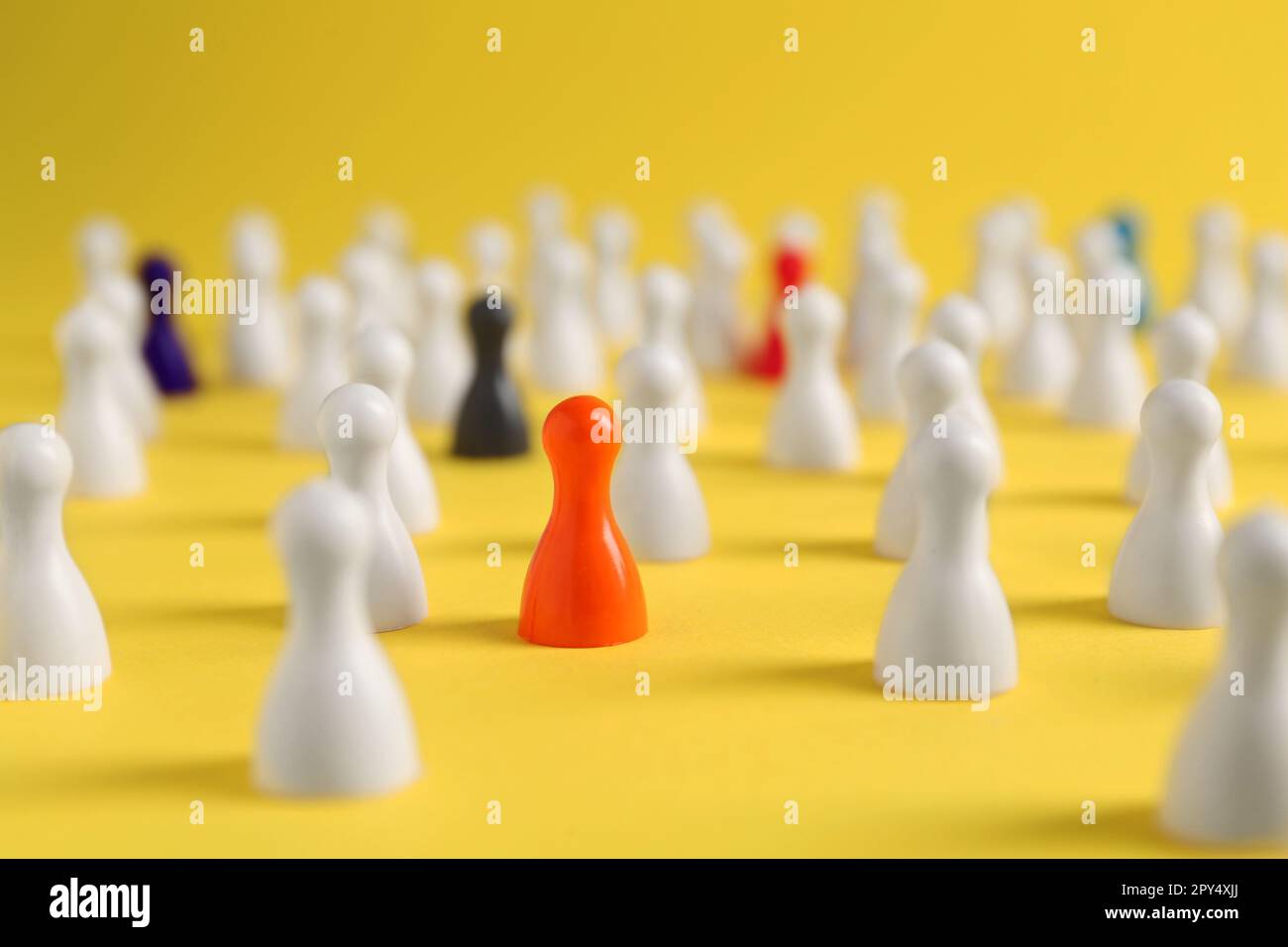 Colorful pawns on yellow background, closeup. Social inclusion concept ...