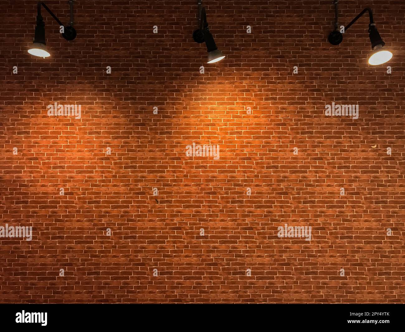 Spot light and brick background Stock Photo - Alamy