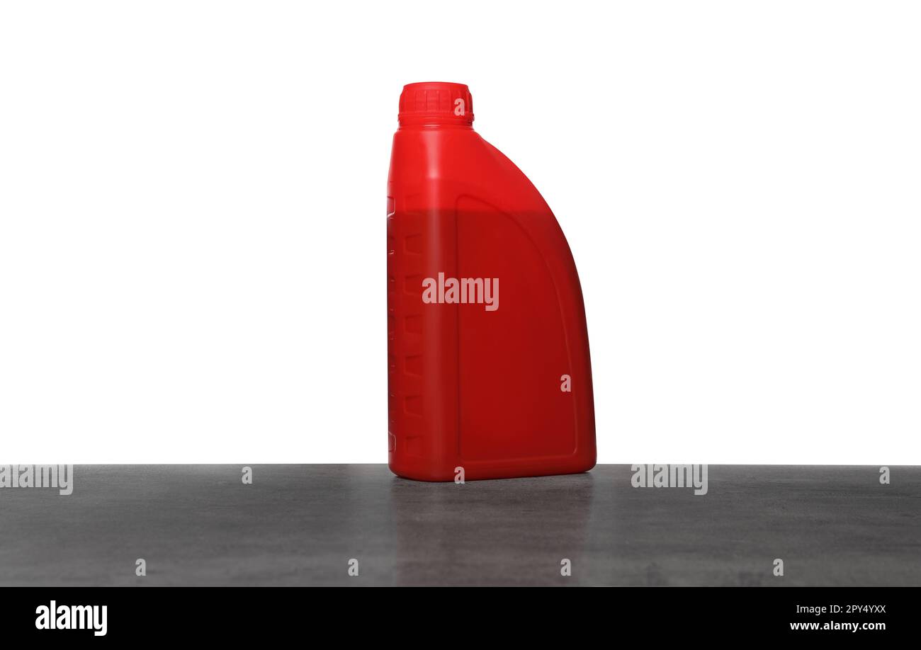 Motor oil in red container on grey table against white background Stock ...