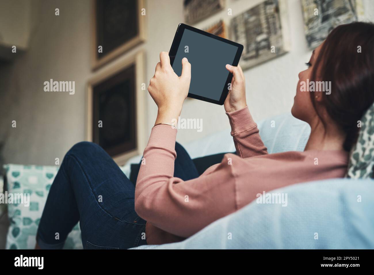 The tv screen looks super tiny these days. a young woman using a ...