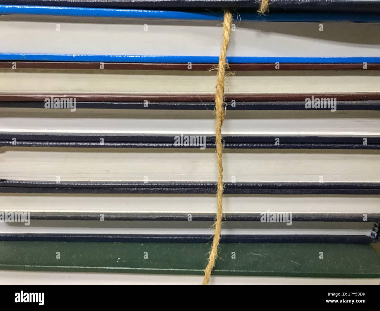Pile of old books with rope background Stock Photo - Alamy