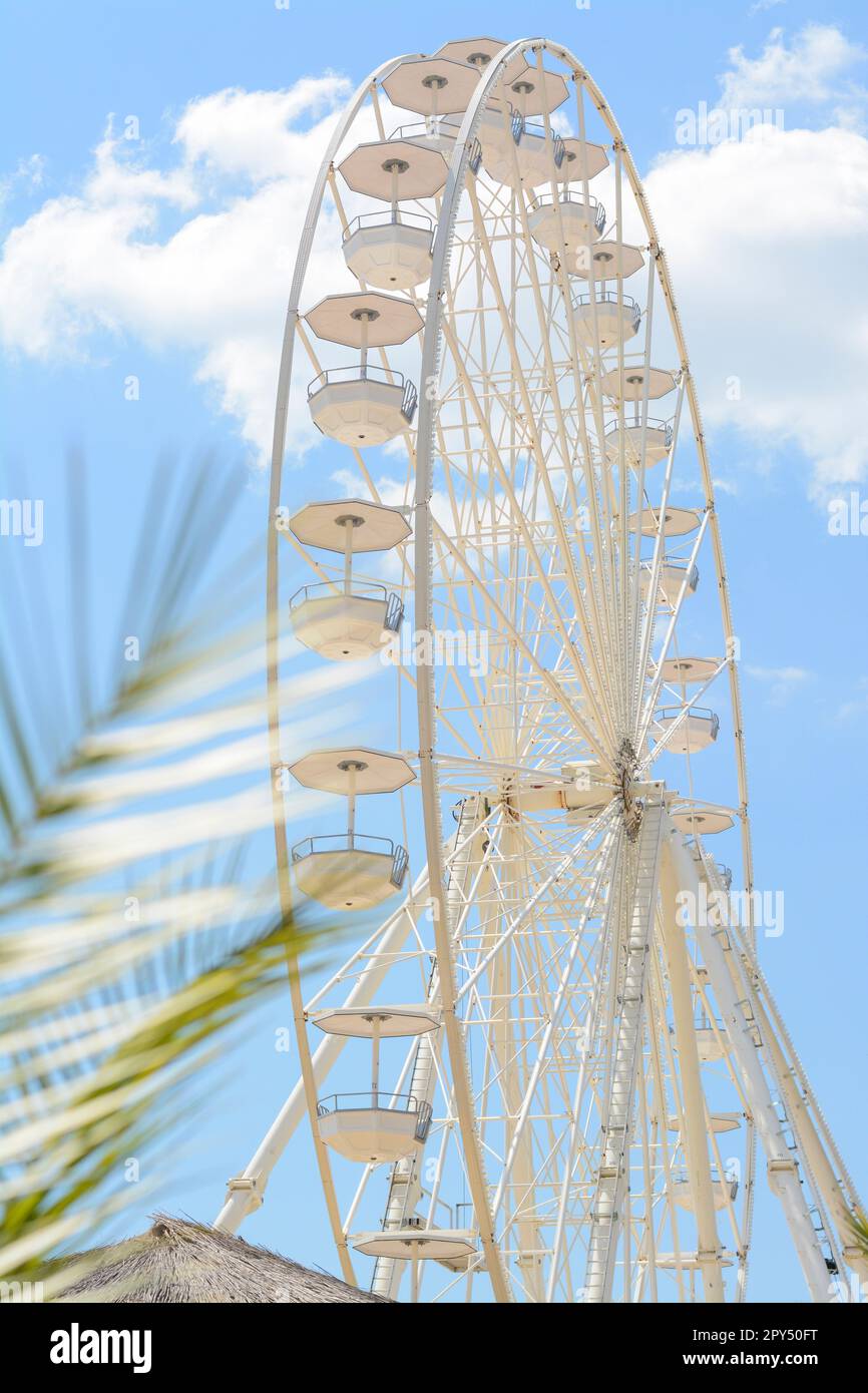 Large white observation wheel against blue cloudy sky Stock Photo - Alamy