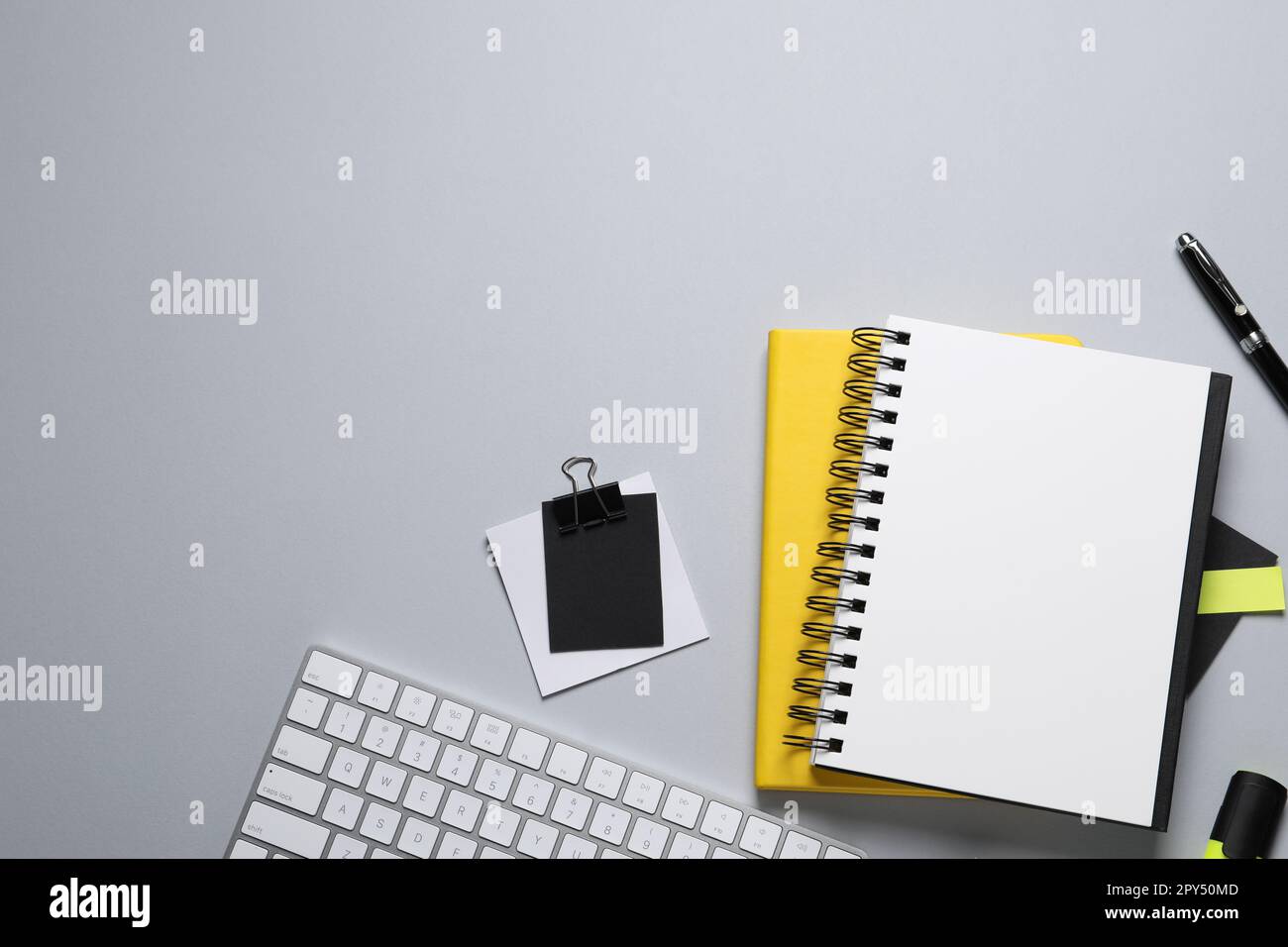 Flat lay composition with stylish notebooks on light grey table, space ...