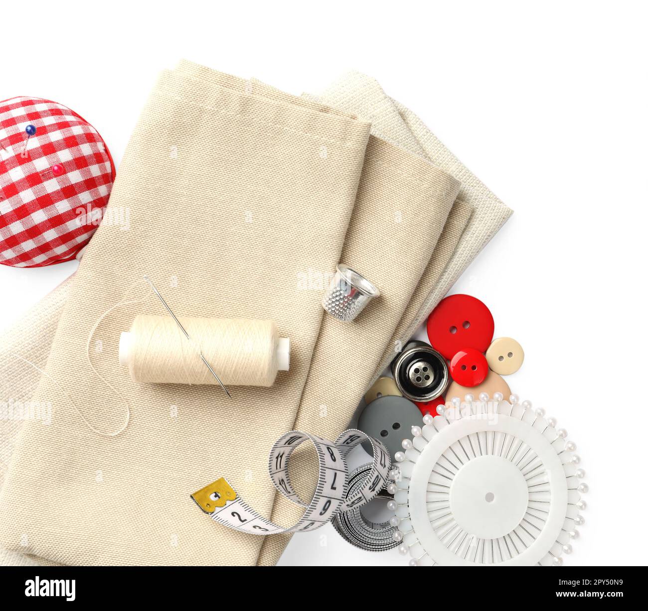 Spool of thread and sewing tools on white background, top view Stock ...
