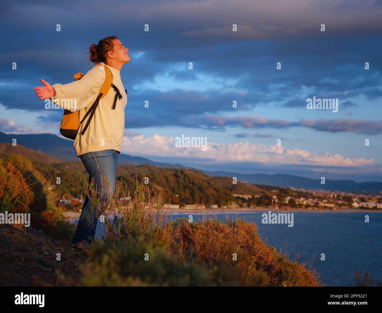 Travel and active lifestyle concept. Happy smiling woman hiking in ...