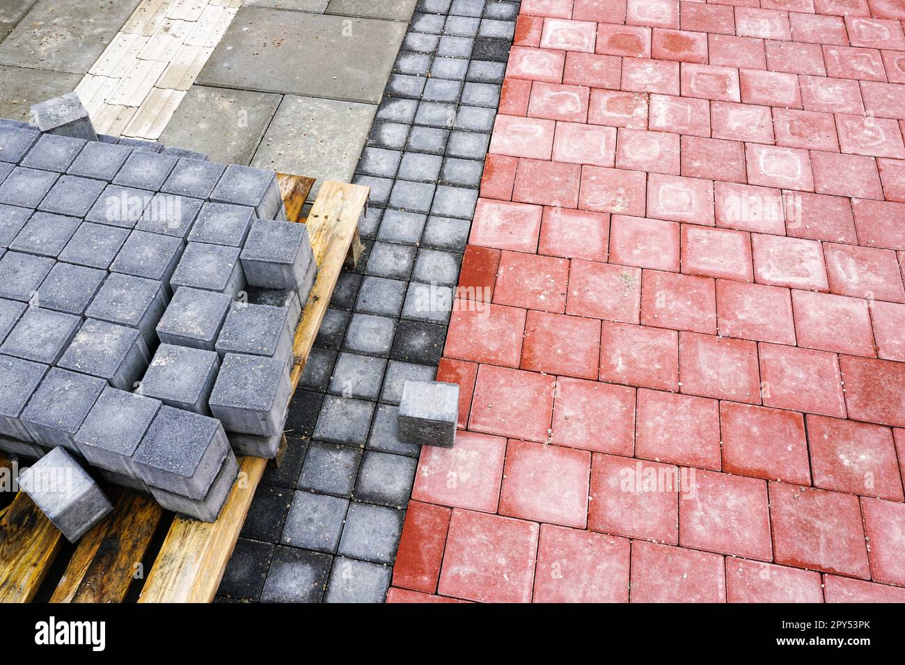 Multicolor paving of a new wide sidewalk with a bicycle path and ...