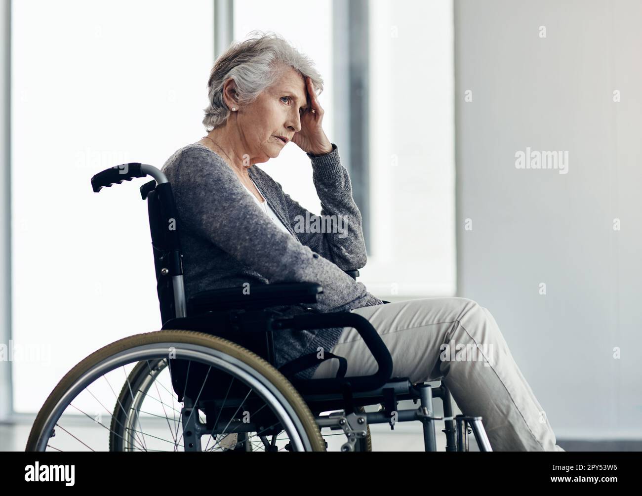 Growing old comes with a lot. a senior woman sitting in a wheelchair ...