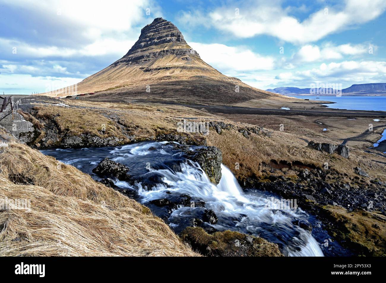 Kirkjufellsfoss waterfall and Kirkjufell mountain on the north coast of ...