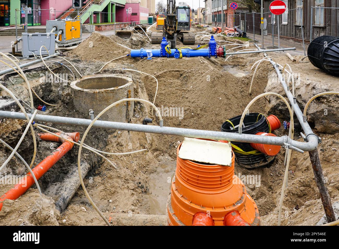 Underground pipe replacement pit on city street, site dewatering system ...