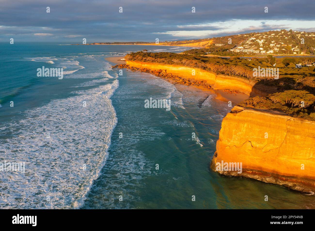 Aerial view of high sea cliffs in morning sunshine at Anglesea on the ...