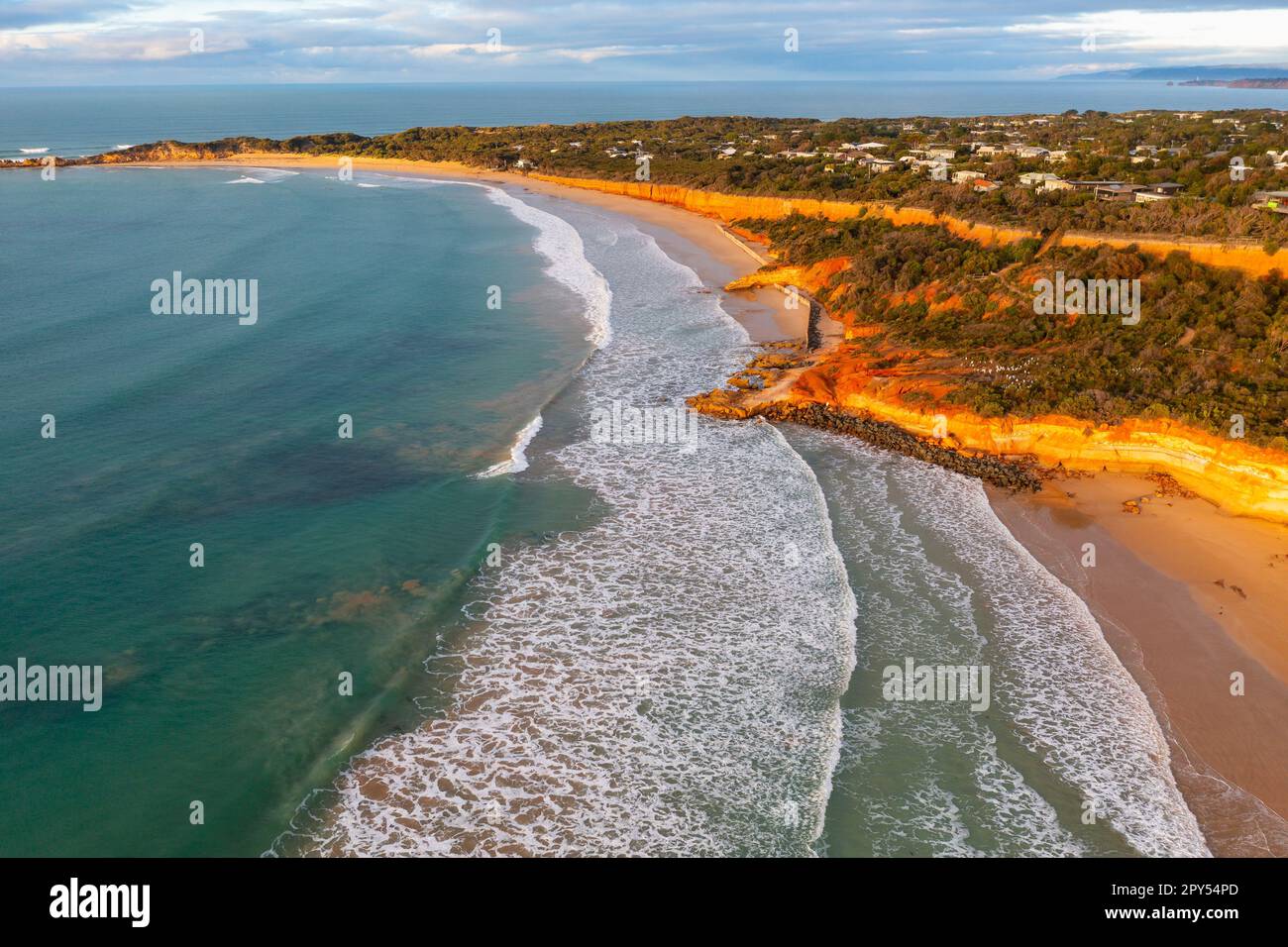 Aerial view of high sea cliffs in morning sunshine at Anglesea on the ...