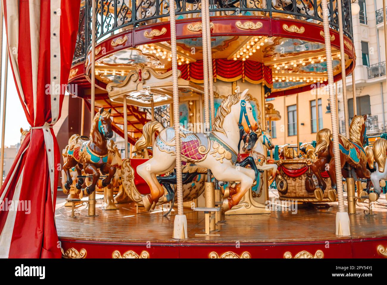 Old carousel in the park. Three horses and a plane on a traditional ...