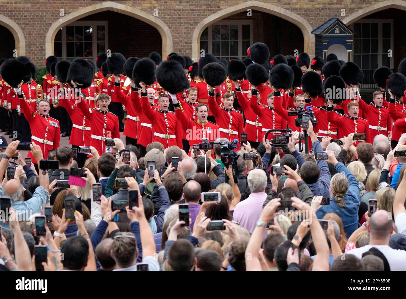 FILE - Members of the public gather as military personnel in ceremonial ...