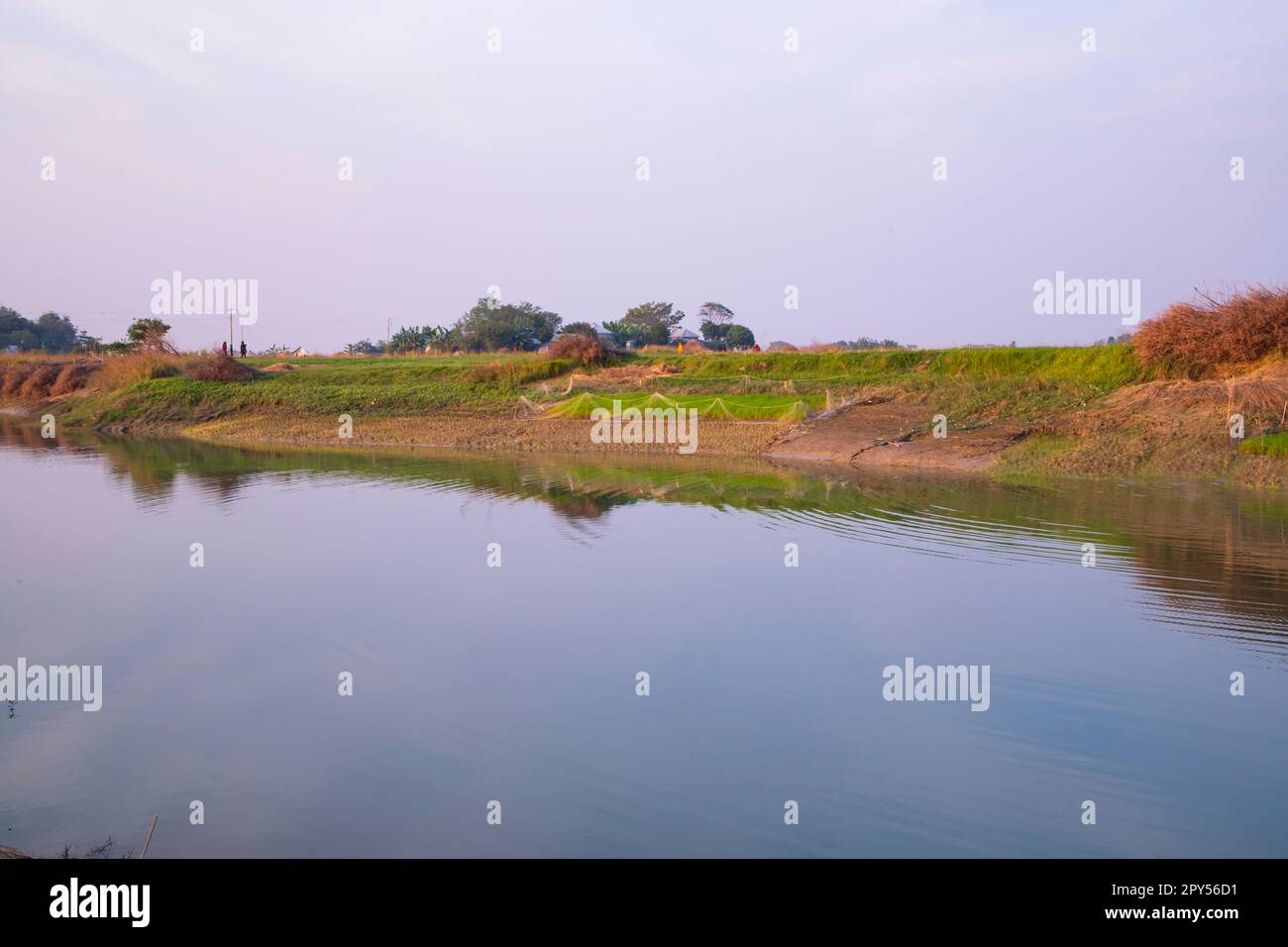 Arial View Canal with green grass and vegetation reflected in the water ...