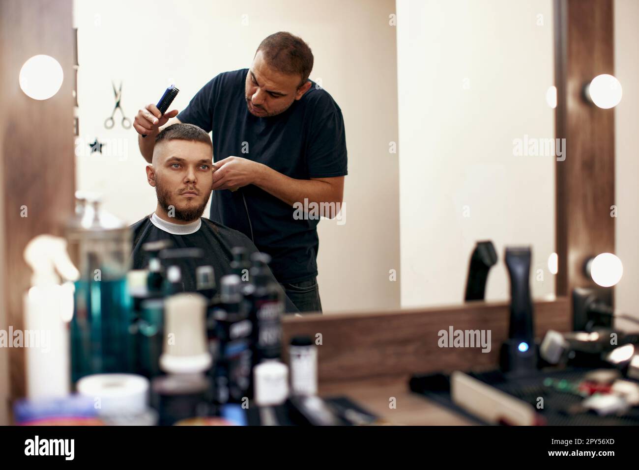 Barber serving client in hair hi-res stock photography and images - Alamy