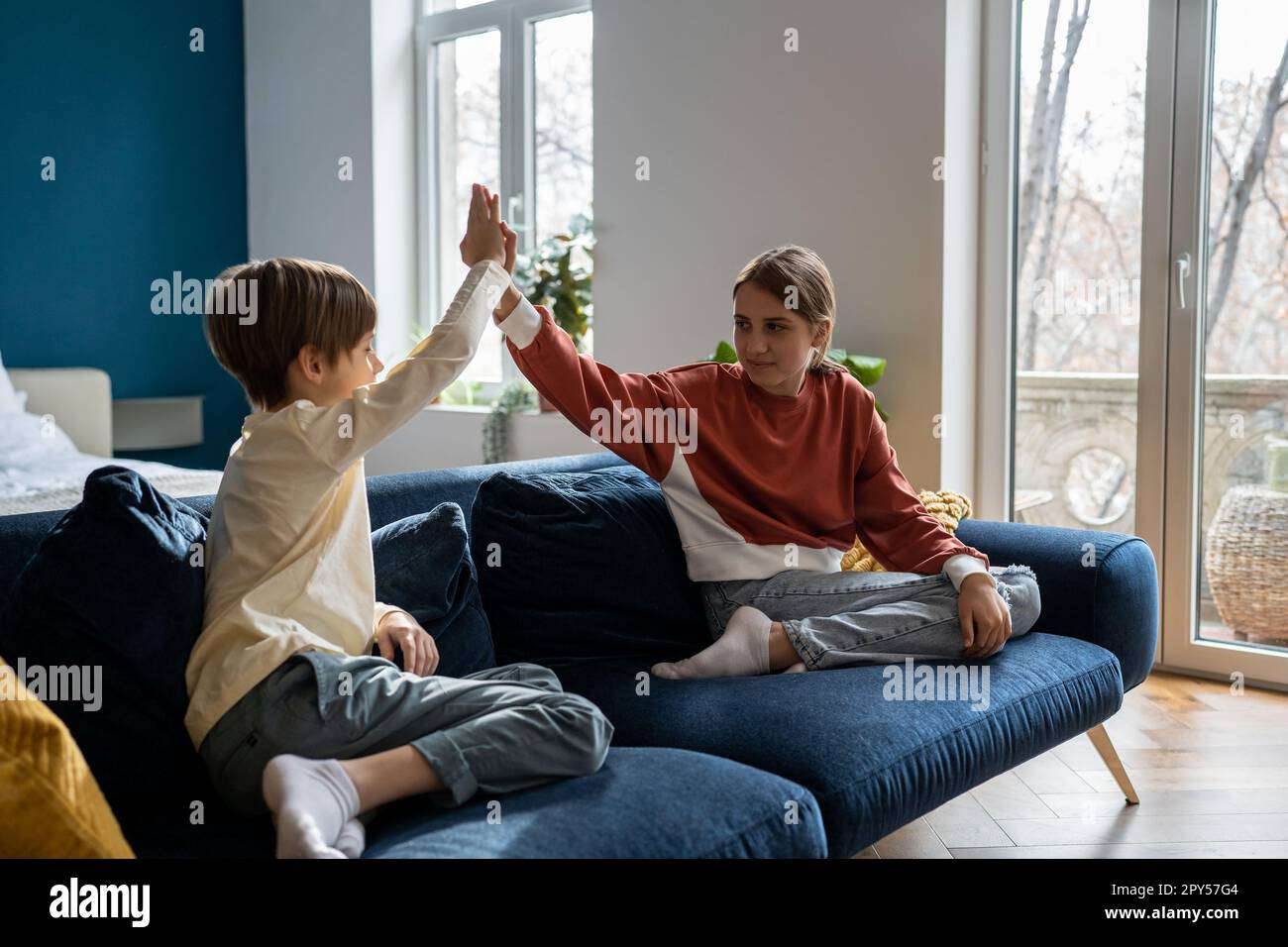 Older sister spending time with younger brother at home Stock Photo - Alamy