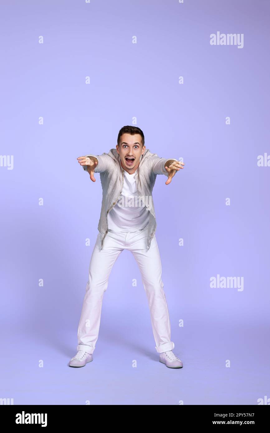 optimistic caucasian young man pointing finger on camera Stock Photo ...