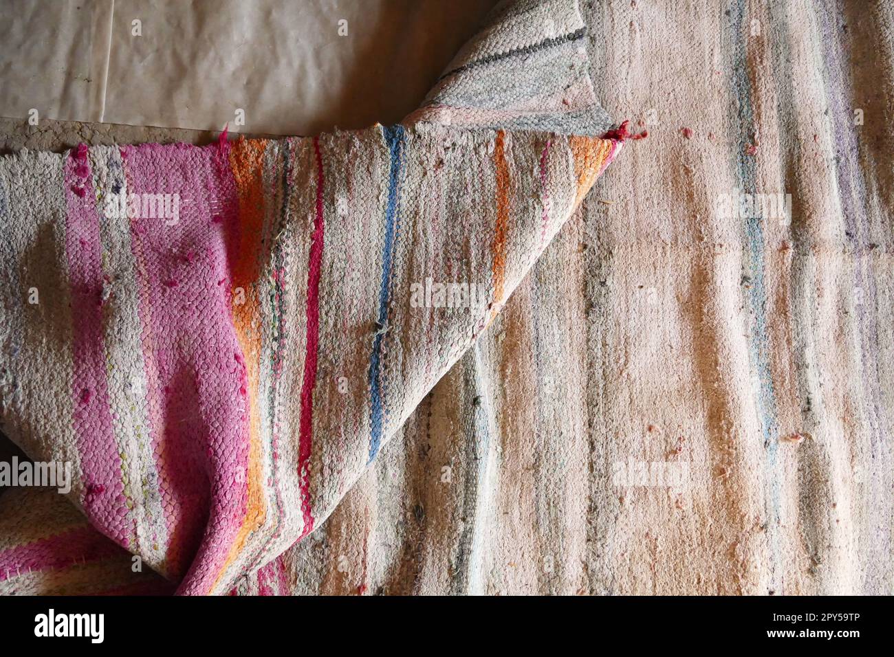 classic old sackcloth-carpet laid on the floor of the village house ...