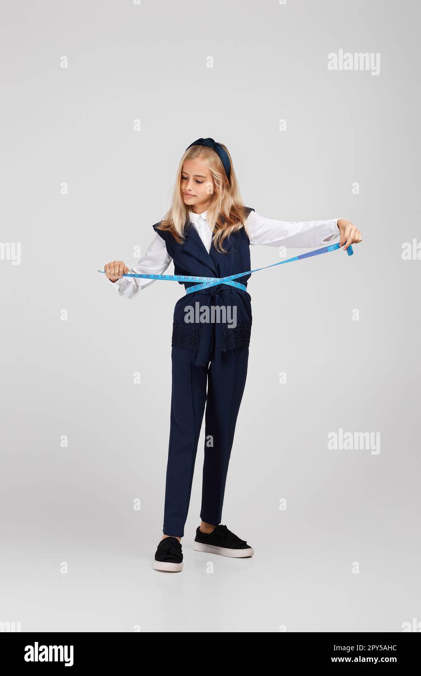 happy little girl holding tape measure Stock Photo - Alamy