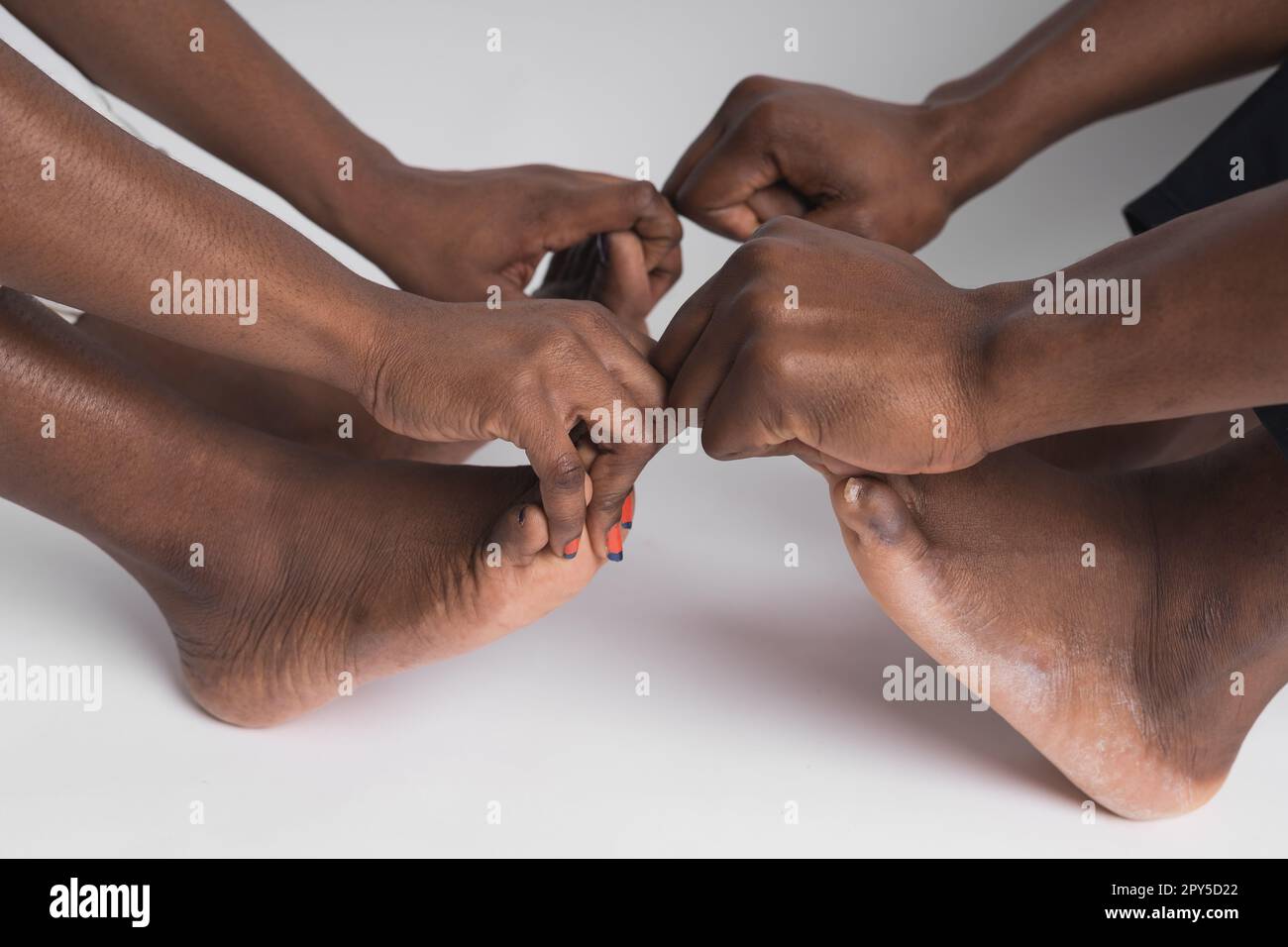 Close up African American man and woman hand and legs touching holding ...