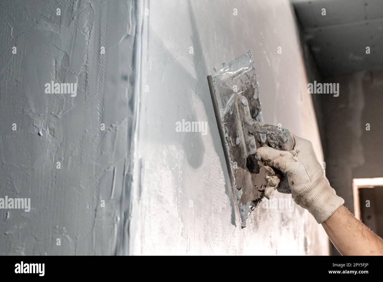 spread the insulation on the wall with a trowel Stock Photo - Alamy