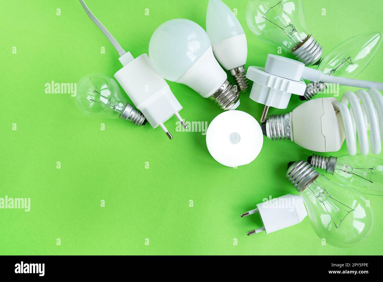 A set of different types of LED lamps isolated on a green background ...